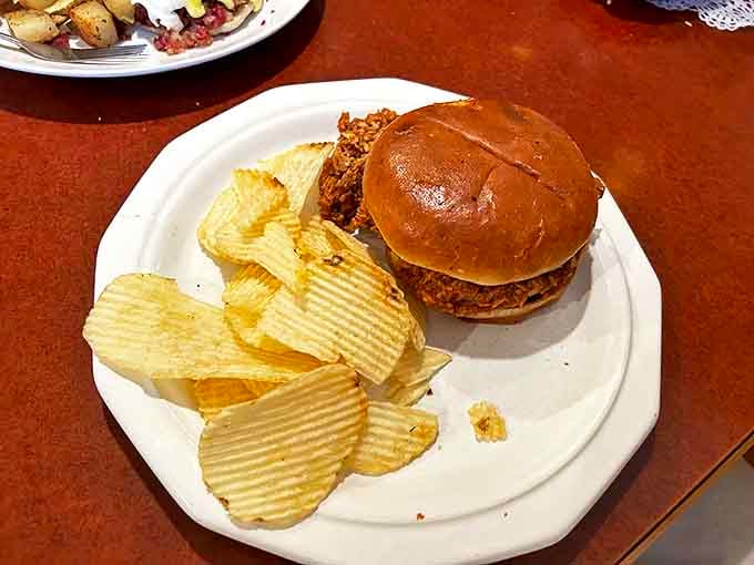 A classic burger on a soft bun with ridged potato chips &ndash; sometimes lunch should be straightforward, satisfying, and served without pretense.