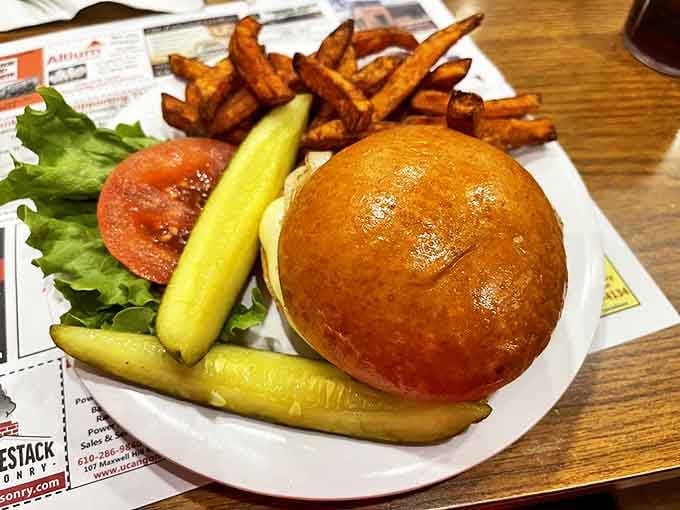 This isn't just a burger&mdash;it's an architectural masterpiece of beef, bun, and garden-fresh toppings with sweet potato fries standing guard.