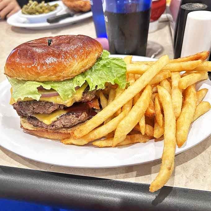 A burger that requires a game plan before tackling. Those golden fries aren't just sides &ndash; they're supporting actors deserving their own award.