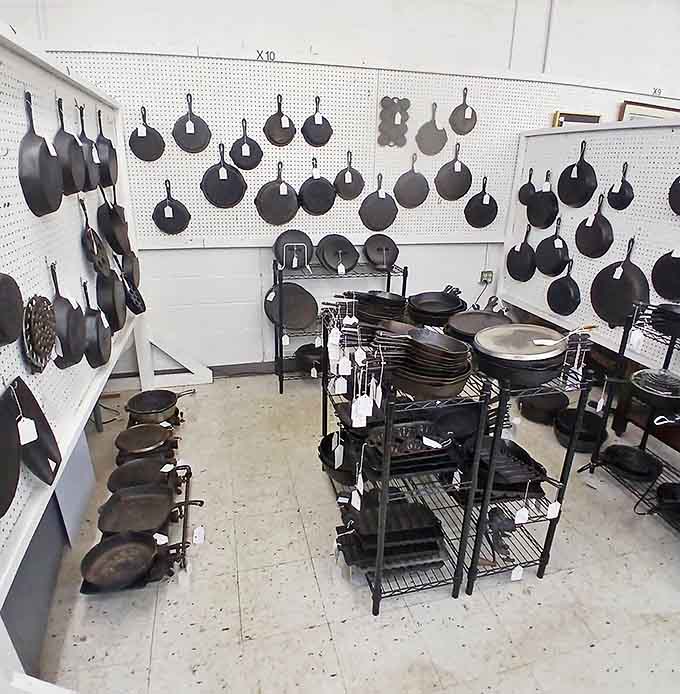 Cast iron heaven! These skillets have been seasoning meals (and biceps) for generations. Cooking history hanging on every hook.