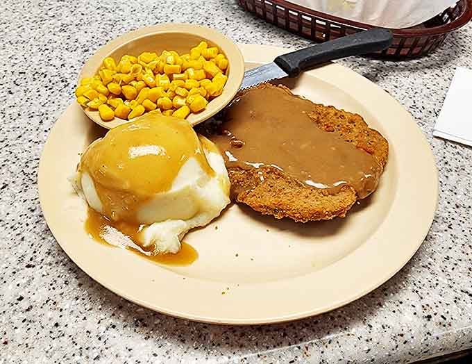 Chicken fried steak swimming in gravy alongside mashed potatoes&mdash;Southern comfort food that hugs your soul before noon.