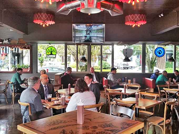 Proof that good barbecue brings people together. Suits, casual wear &ndash; doesn't matter when there's smoked meat on the agenda and those red lights overhead.