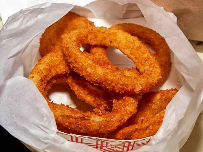 Golden rings of crispy perfection that make you wonder why anyone bothers with straight-cut potatoes when circles clearly taste better.