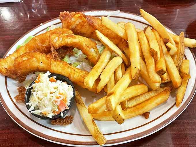 Fish and chips with a golden batter so crisp you can hear it from across the room. Cole slaw stands by, ready for duty.