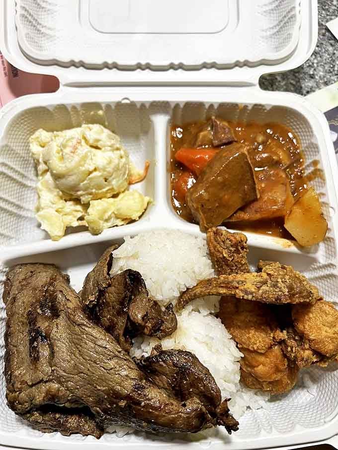 The Hilo Boy Plate—where mac salad, rice, meat, and stew coexist in perfect harmony like the world's most delicious peace summit.