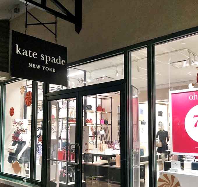 Kate Spade's gleaming storefront showcases colorful handbags arranged like edible confections. The bright displays are basically a siren song for anyone with a weakness for structured totes.