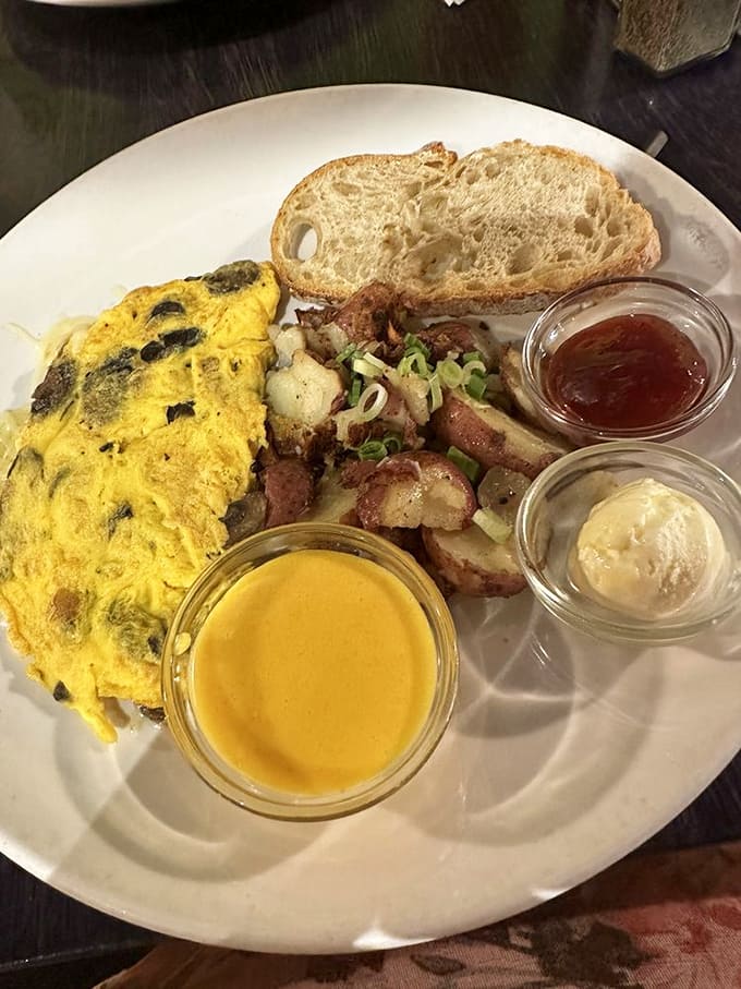 An omelet that clearly went to culinary school, served alongside artisanal toast and those legendary potatoes that have achieved local celebrity status.