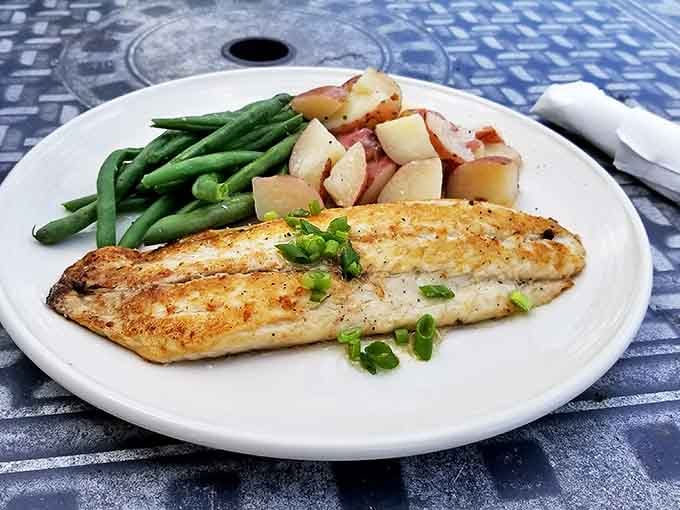 Pan-roasted trout that looks like it jumped from stream to plate, keeping company with green beans that actually taste like vegetables should.