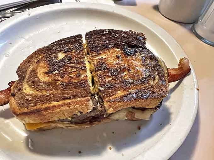 The Patty Melt – where burger meets grilled cheese in a beautiful marriage that would make any cardiologist nervously clear their throat.