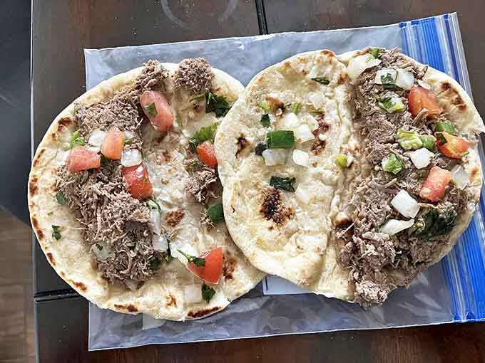 Barbacoa tacos presented with the simplicity they deserve&mdash;tender, shredded beef topped with fresh onions and cilantro on handmade tortillas. No passport required for this authentic journey.