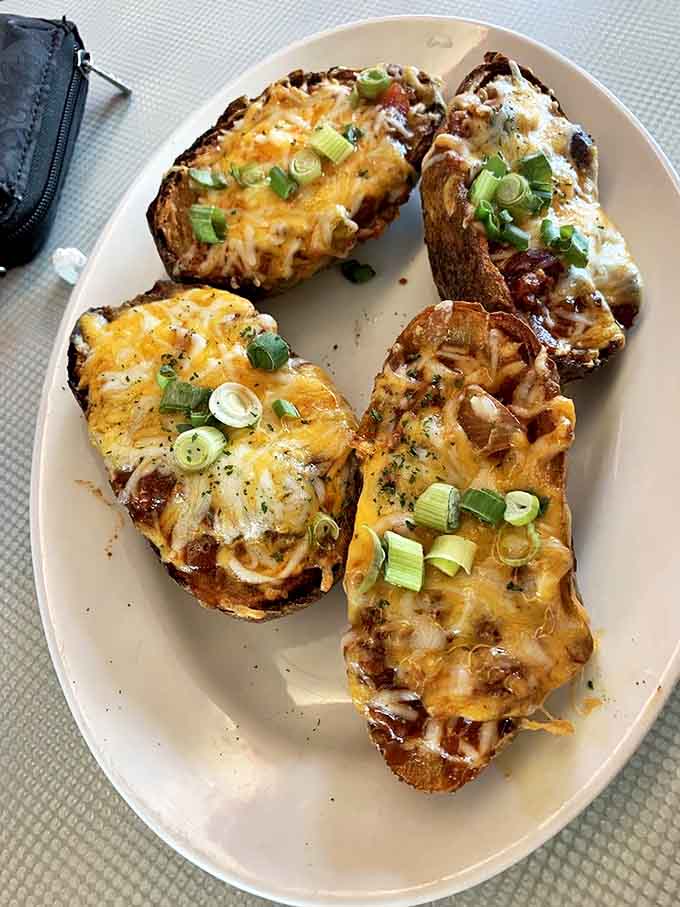 Potato skins that don't skimp on the good stuff—where the cheese-to-scallion ratio has been perfected through years of delicious research.
