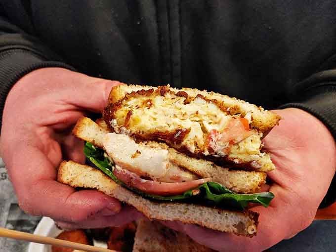 This sandwich isn't just stacked&mdash;it's architecturally significant. Layers of seafood goodness requiring both hands and absolutely zero dignity to consume.
