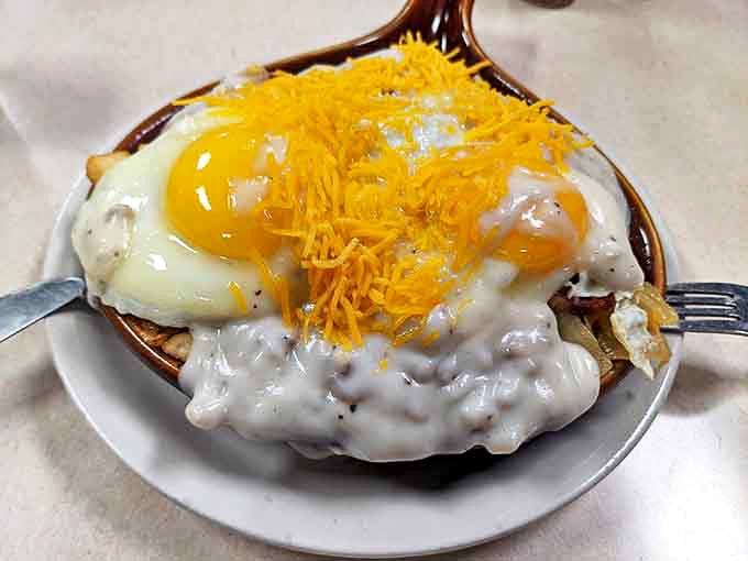 Breakfast doesn't get more serious than this skillet &ndash; eggs, gravy, and cheese creating a morning masterpiece that demands your full attention.