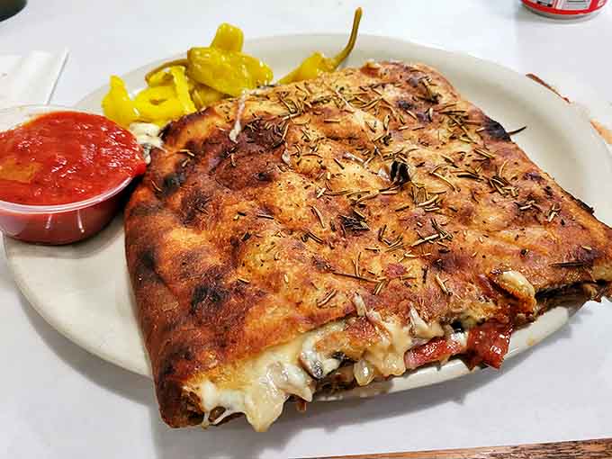Not just a calzone&mdash;a stromboli revelation. Crispy, herb-dusted exterior giving way to a molten interior that makes you forget all other handheld foods exist.