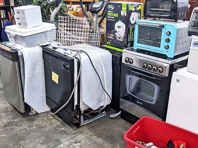 The appliance graveyard or kitchen resurrection center? That retro blue toaster oven might just outlast anything you'd buy new today.