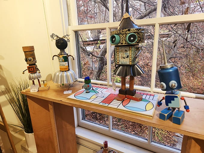 Whimsical robot sculptures stand guard by the window, assembled from vintage odds and ends&mdash;literary companions with mechanical hearts.