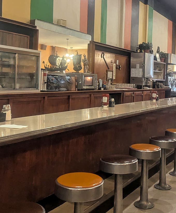 The counter seating &ndash; where solo diners become temporary family and the colorful striped wall behind serves as a cheerful backdrop to morning rituals.