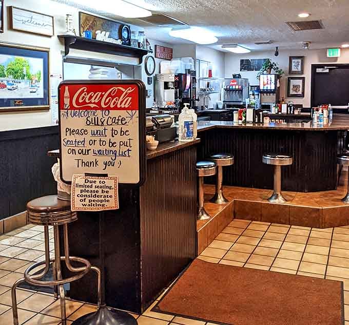 The counter seating area, where solo diners become temporary family and the "Please Wait to be Seated" sign is the only thing standing between you and bliss.