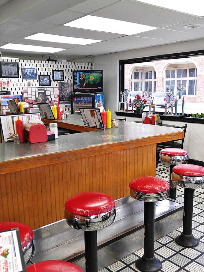 The counter seating—where regulars perch like birds on a wire, watching short-order magic happen while trading gossip and weather predictions.