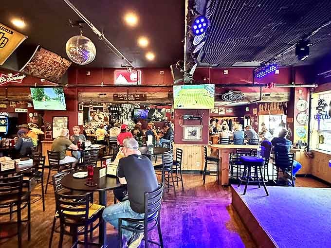 The saloon side buzzes with energy as locals and travelers alike gather under disco balls and TV screens—pizza pilgrims united in their quest.