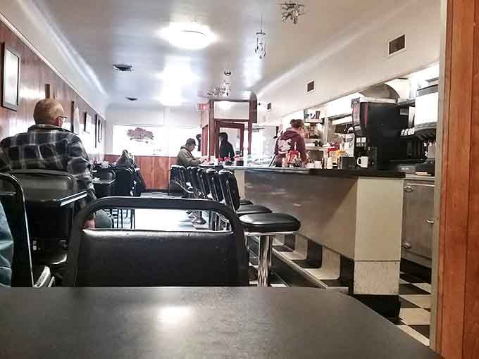 Classic diner counter magic in action &ndash; where regulars become family and the coffee never stops flowing. The checkered floor isn't just decoration; it's a promise of authenticity.