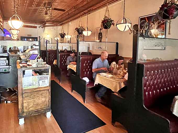 Leather booths and vintage lighting create the perfect backdrop for conversations that flow as smoothly as the after-dinner coffee.