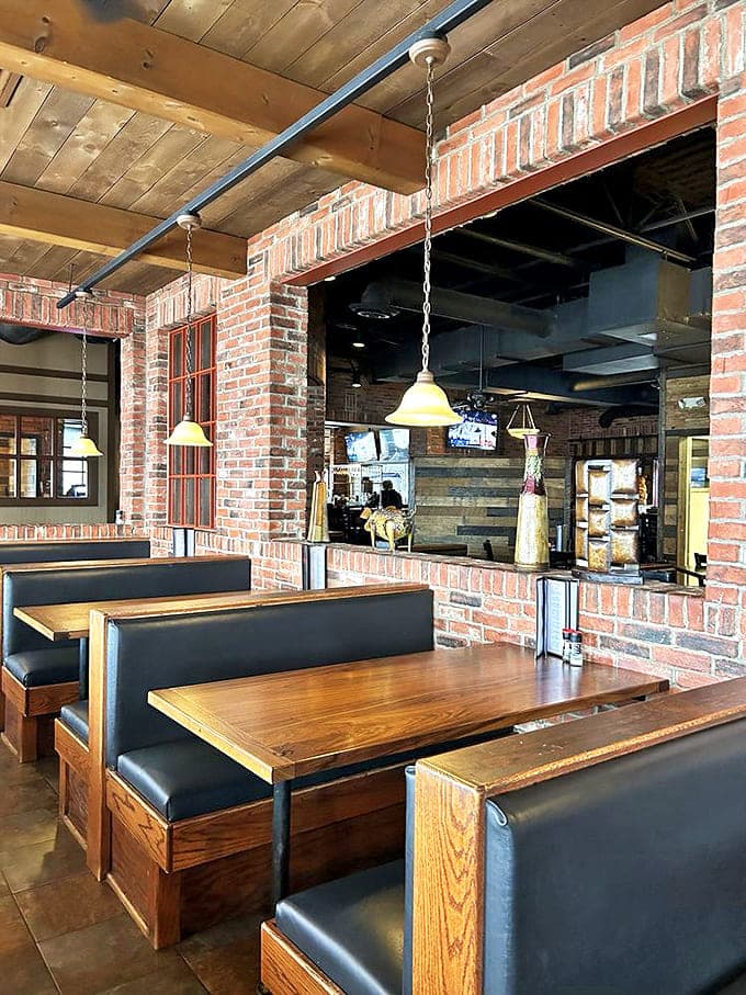 Booths that invite lingering conversations and second rounds. The brick archways frame each dining space like a stage for your culinary adventure.