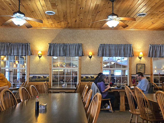 Black and white checkered curtains, wooden ceiling fans, and warm lighting create the kind of dining room where calories don't count and diet plans go to die.