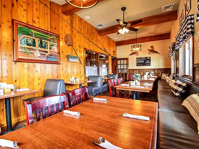 Knotty pine walls and checkered curtains frame this dining room where strangers become neighbors over plates of morning magic.