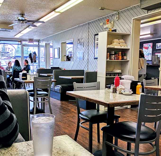 The dining area: where strangers become temporary breakfast companions. The diagonal wood paneling adds a touch of retro charm that screams "trust our pancakes."