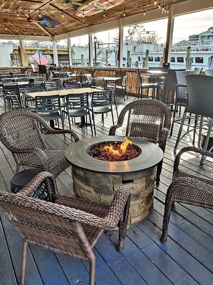 String lights, wooden beams, and a fire pit create the kind of outdoor dining space where one drink easily turns into "let's stay for dinner."