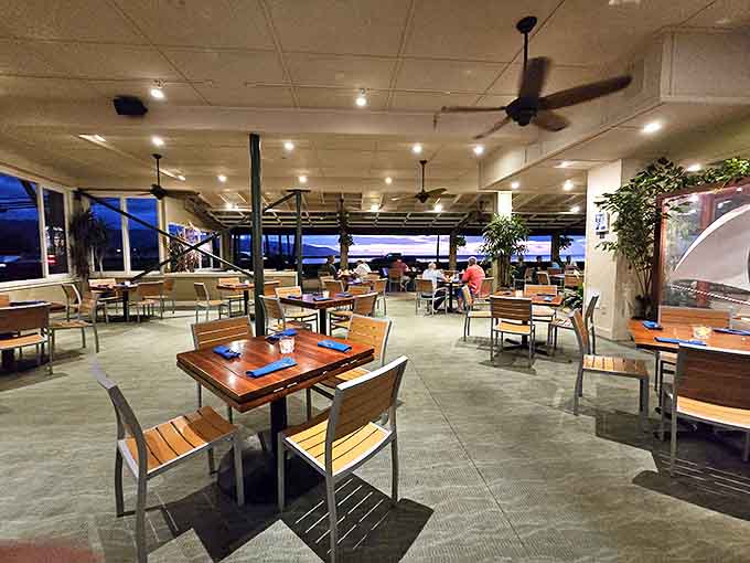 As evening settles in, the dining room transforms into a sanctuary of good food and ocean breezes.