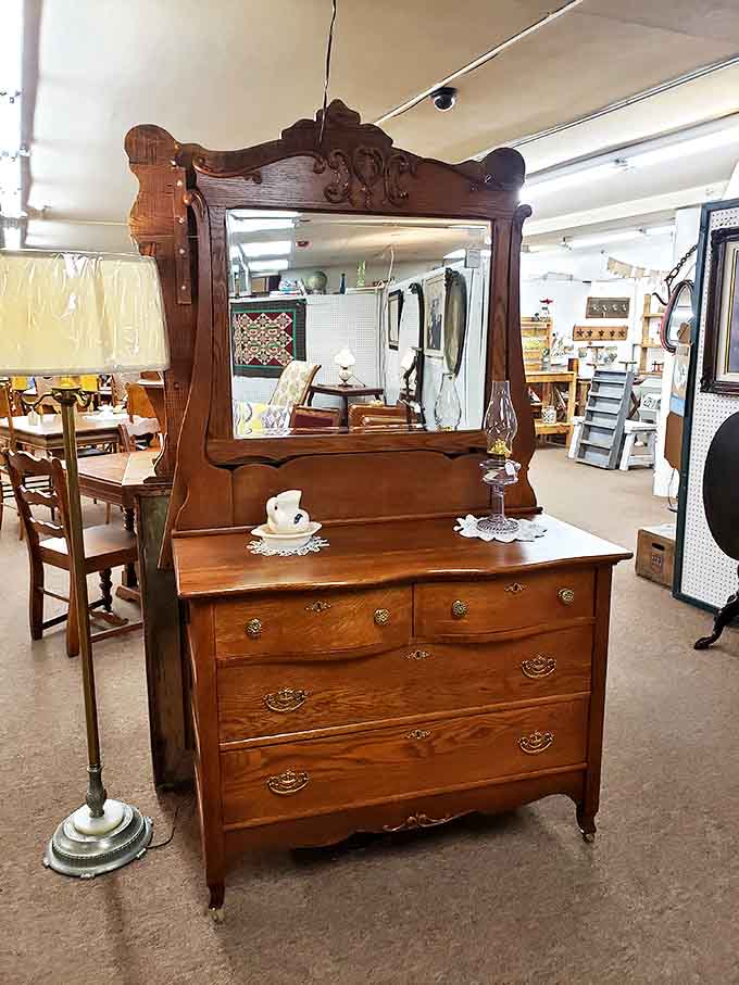 This oak dresser with beveled mirror has witnessed more outfit changes and personal confessions than a backstage dressing room at Broadway.