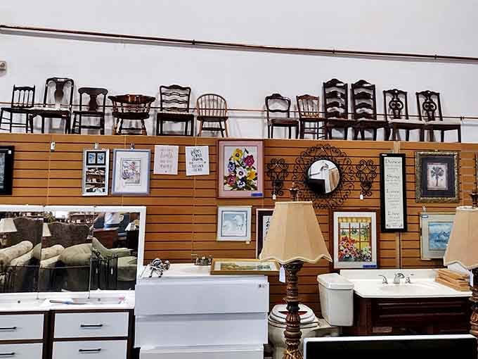 Chairs that have seen a thousand dinner conversations perch above bathroom fixtures and framed art&mdash;the ReStore's version of a gallery wall.