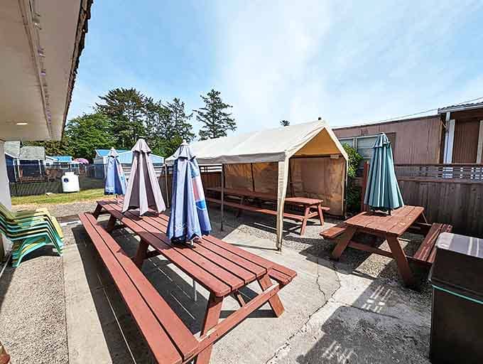 The outdoor seating area waits patiently for hungry travelers, picnic tables standing at attention like culinary soldiers ready for the next flavor battle.
