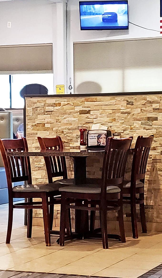 Classic diner seating with stone accents and a mounted TV&mdash;because sometimes you need to catch the game while catching up with your omelet.