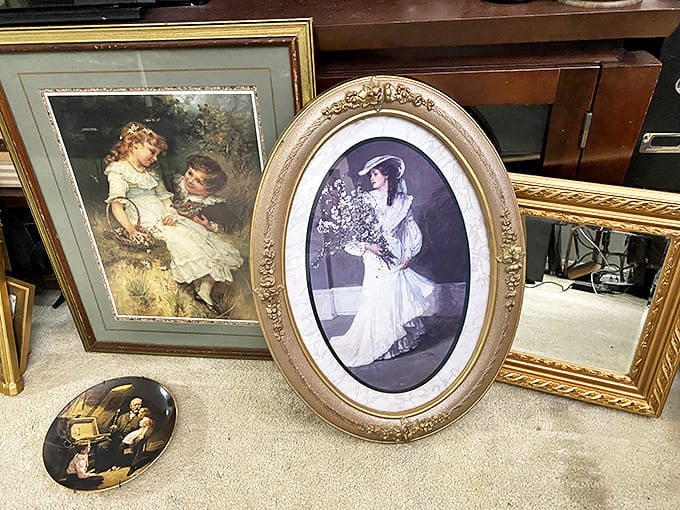 Framed elegance from another era waits for new walls to adorn. Someone's grandmother's portrait becomes someone else's vintage find.