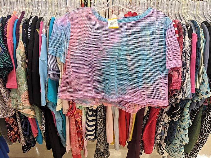 Fashion's second chances hang in colorful rows. That mesh top someone regretted buying is about to become someone else's festival statement piece.