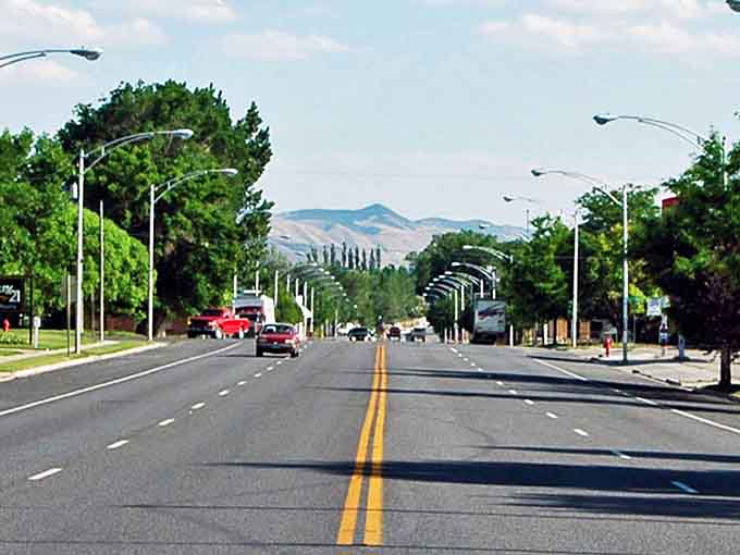 Gunnison's main street stretches toward distant hills, inviting you to follow the road wherever it leads.