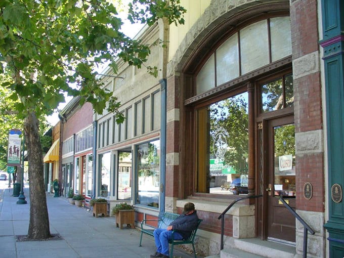 A peaceful moment in downtown Dayton where tree-lined sidewalks and historic storefronts create the perfect setting for relaxation.