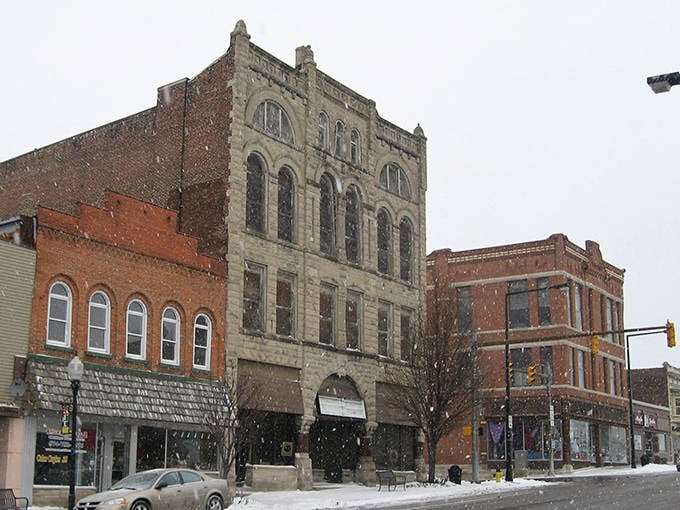 Winter snow blankets Logansport's historic brick buildings, creating a picturesque scene that highlights the town's timeless architectural beauty.