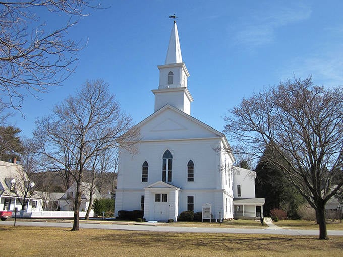 The classic white-steepled church in Walpole represents the timeless New England character found in these peaceful retirement communities.