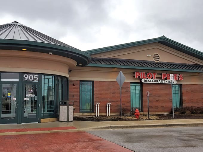 The bright red sign beckons like a beacon for hungry aviation enthusiasts and curious suburbanites alike.