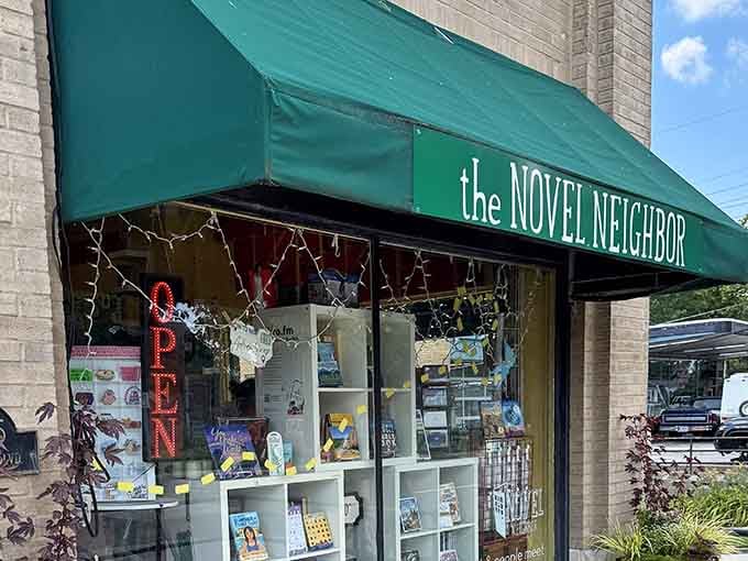 The green awning and twinkling lights create that perfect small-town bookstore vibe we all remember from childhood.