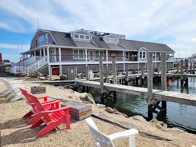 That weathered shingle exterior and those fire-engine red chairs are basically screaming "park here and prepare for magic."