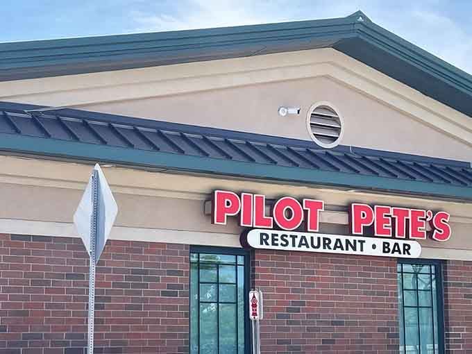 The bright red sign beckons like a beacon for hungry aviation enthusiasts and curious suburbanites alike.