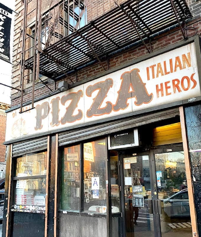 That weathered sign isn't a design choice, it's a badge of honor earned through decades of pizza perfection.