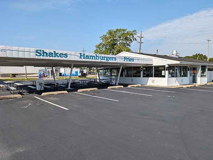 That classic drive-in silhouette against the sky is basically a love letter to America's automotive glory days.