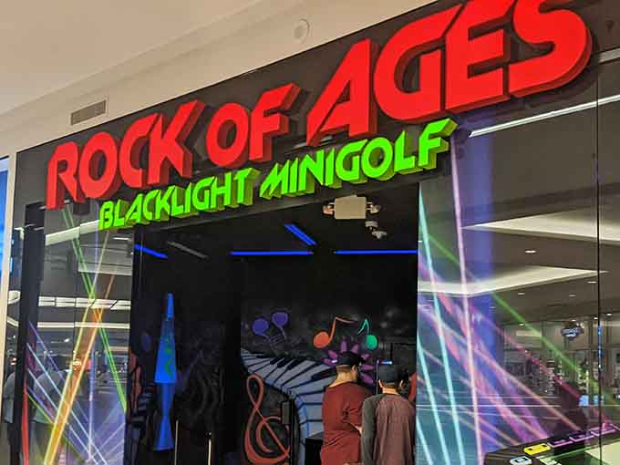 Neon lights and classic rock vibes set the scene for glowing fun at Rock of Ages Blacklight Minigolf in Bloomington.