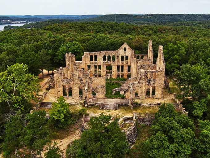 An aerial view reveals the full scope of these stunning castle ruins nestled in the Ozark forest overlooking Lake of the Ozarks.